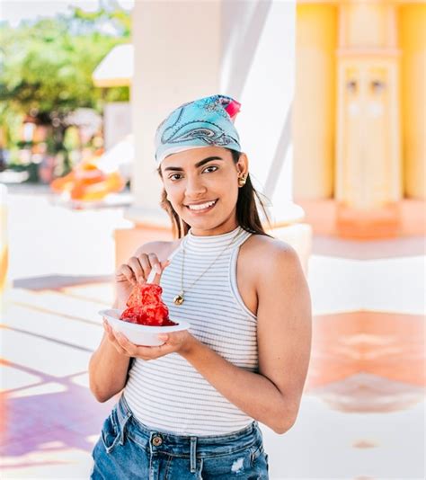 Premium Photo Portrait Of Smiling Girl Holding Shaved Ice In The