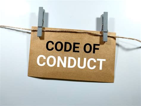 Word CODE Of CONDUCT On Brown Paper With Clothespins On White Background Stock Photo Image Of