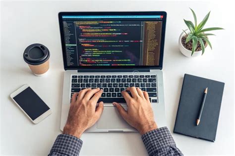 Person Coding On A Laptop With Vibrant Programming Code On The Screen