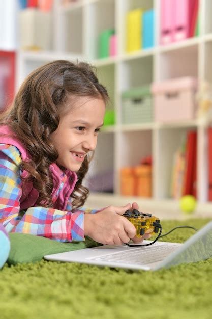 Premium Photo Cute Girl Playing Computer Game With Laptop