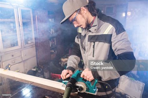 젊은 목수 톱 밥의 흡입과 함께 전기 비행기로 작업 하는 수염 수평 및 샌 딩 나무 바 강철에 대한 스톡 사진 및 기타 이미지 강철 건설 기계류 건설 산업 Istock