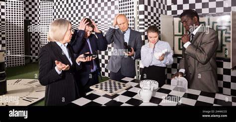Businesspeople Solving Conundrum Together Near Chessboard Stock Photo Alamy
