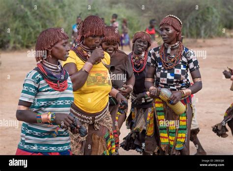 Women Dance Blow Brass Horns At Mursi Tribe Ethnic Group Coming Of Age