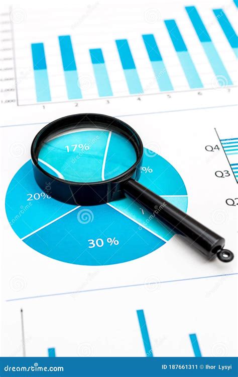 Magnifying Glass On Business Graphs And Charts Financial Concept Stock