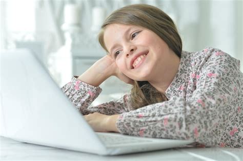 Premium Photo Cute Girl Using Laptop At Home
