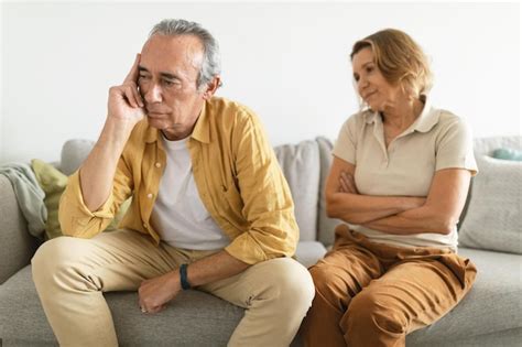 Premium Photo Senior Wife And Husband Sitting Apart On Couch Feeling