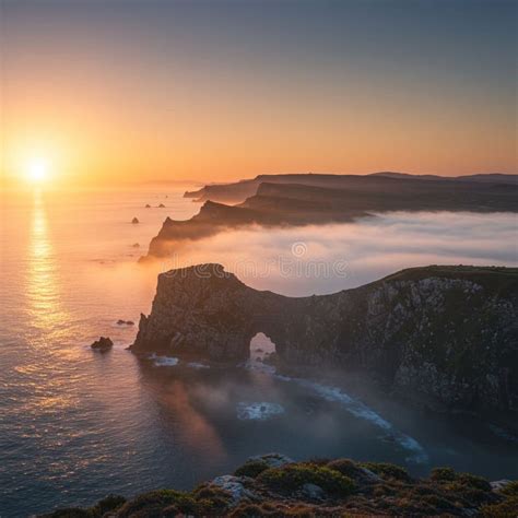 Coastal Landscape At Sunset With Rugged Cliffs And A Natural Sea Arch