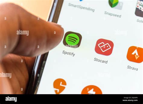 Adult Male Operating Smartphone And Selecting Spotify App On The Screen Stock Photo Alamy