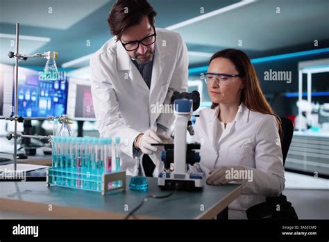 Scientist Couple Conducting Experiments In Hospital Lab With State Of