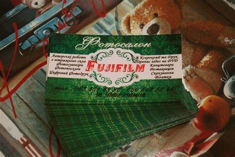 a pile of green business cards sitting on top of a table next to a ...