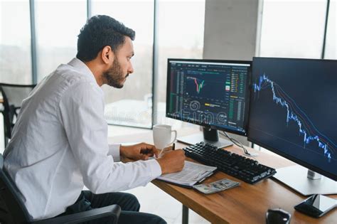 Young Indian Business Man Trader Looking At Computer Screen With