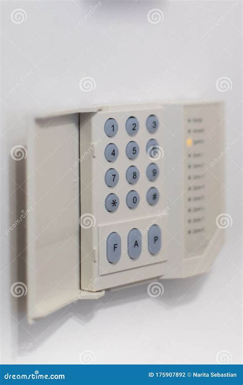 A Regular Security Systems Keypad With Buttons And A Plastic Flap