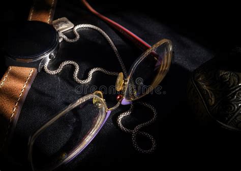 Still Life With Glasses Watch And Chain In A Strip Of Light Stock