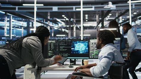 Admin In Wheelchair And Data Center Coworker Work Together Using Node