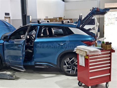 A Car Is Raised Up Using A Lift Inside A Service For Maintenance Stock