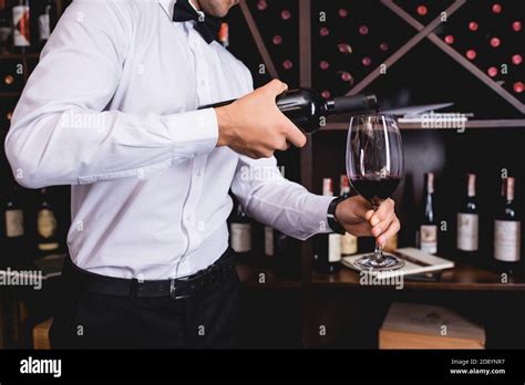Cropped View Of Sommelier In Formal Wear Pouring Wine In Restaurant