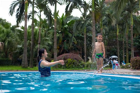 Babe Asian Babe Having Fun With His Mother In The Swimming Pool By Stocksy Contributor Bo Bo