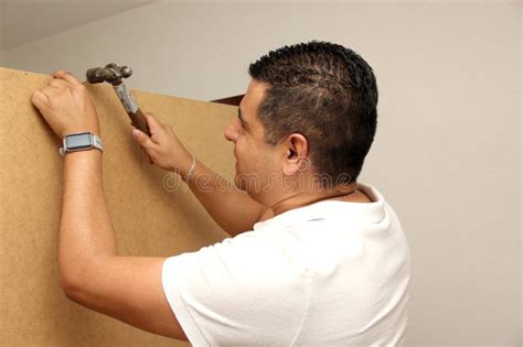 Dark Haired Year Old Latino Repairman Man Works With Hammer And