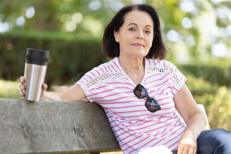 Happy Mature Woman Sitting Outdoor And Thinking Stock Image Image Of