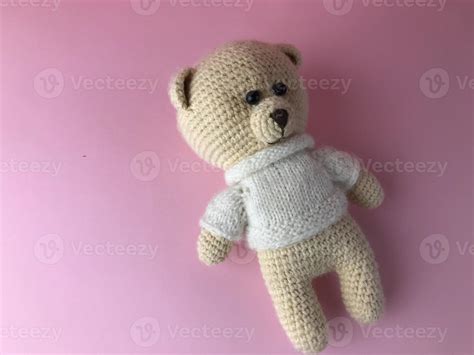 Interior Toy Soft Knitted Bear On A Pink Background In The Corner Of