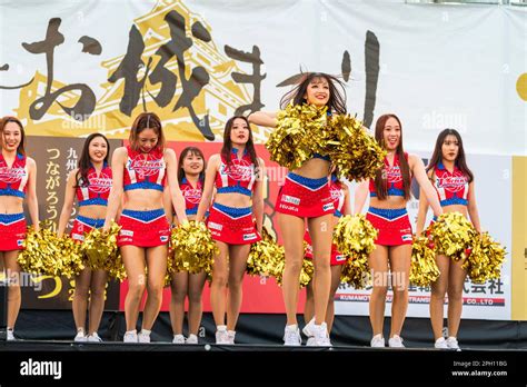 Group Of Young Japanese Women In Skimpy Cheerleader Costumes On An