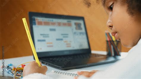 African Girl Moving Touch Pad While Using Laptop Programing Code And Writing Prompt Code In Stem