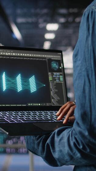 Vertical Close Up Of Admin In Data Center Using Laptop To Monitor Neural Network Llm