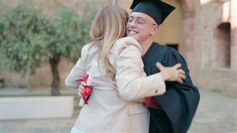 Man And Woman Mother And Son Hugging Each Other Celebrating Graduation