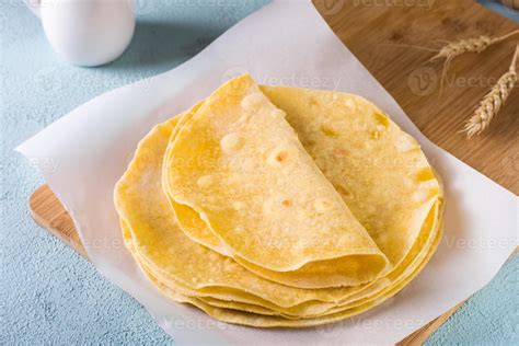 Stack Of Flat Mexican Corn Tortillas On Wooden Board On Table 16586202