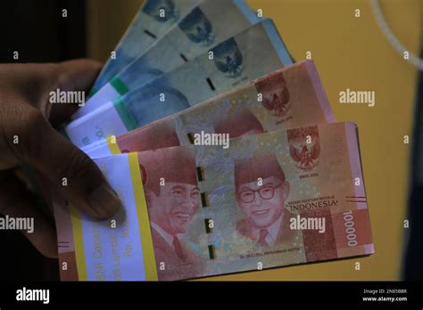 Stacks Of Idr 100000 And Idr 50000 Rupiah Banknotes On Black Stacks Of Idr 100000 And Idr 50000 Rupiah Banknotes On Black