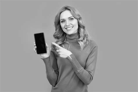 Premium Photo Happy Girl Pointing Finger At Mobile Phone Pointing