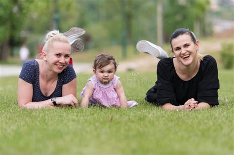 Mother And Aunt Lying With Baby Outdoors Stock Photo Image Of Nature Warm