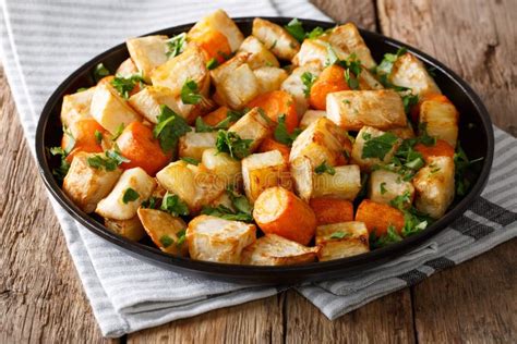 Roasted Organic Celery Root And Carrots Close Up On A Plate Horizontal