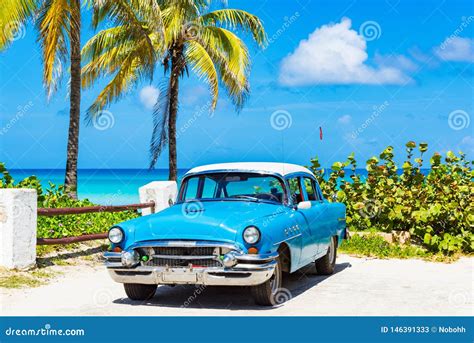 American Blue White Vintage Car Parked On The Beach In Varadero Cuba