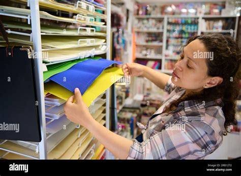 Beautiful Pregnant Woman Designer Artist Choosing Color Vibrant Cardboard Sheets On Shelves