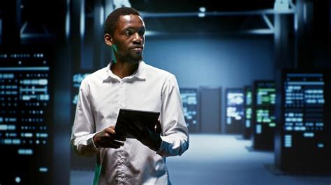Premium Photo Technician Doing Checkup In Server Room