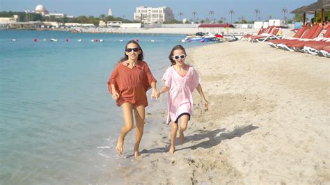 Little Happy Funny Girls Have A Lot Of Fun At Tropical Beach Playing