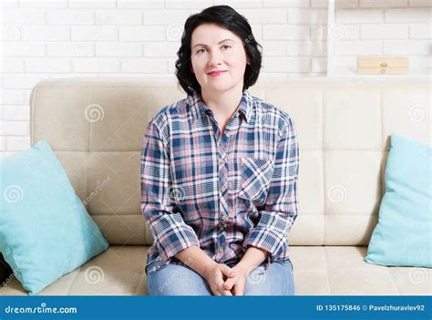 Portrait Of Beautiful Woman Sitting On Sofa Attractive Female Relaxing