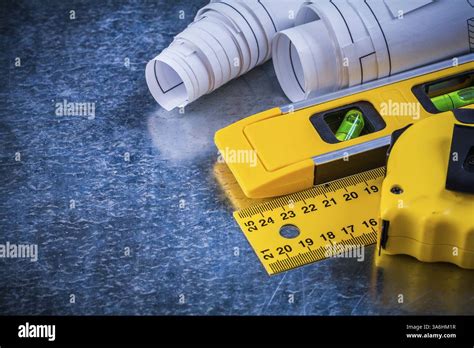 Ruler Measuring Tape Construction Level And Blueprints On Metallic Scratched Background Building