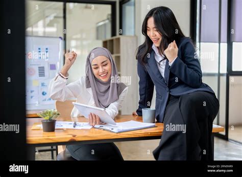 A Cheerful And Beautiful Asian Muslim Businesswoman Or Female Office