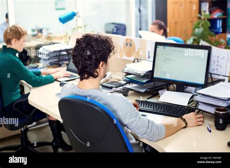 The Concept Of Office Work Rear View Man Working At A Comput Stock
