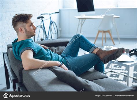 Man Sitting On Couch Man Sitting On Couch Hd Stock Images