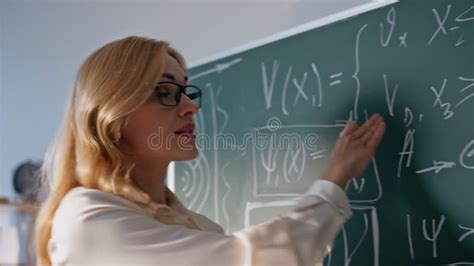 College Teacher Teaching Class Showing Physics Formulas On Blackboard Closeup Stock Footage