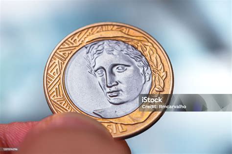 브라질 레알 Brl 동전 은행 통화 통화 손 100 Reais 지폐의 흐릿한 배경으로 하나의 진짜 동전을 들고 있는 남자 개념에