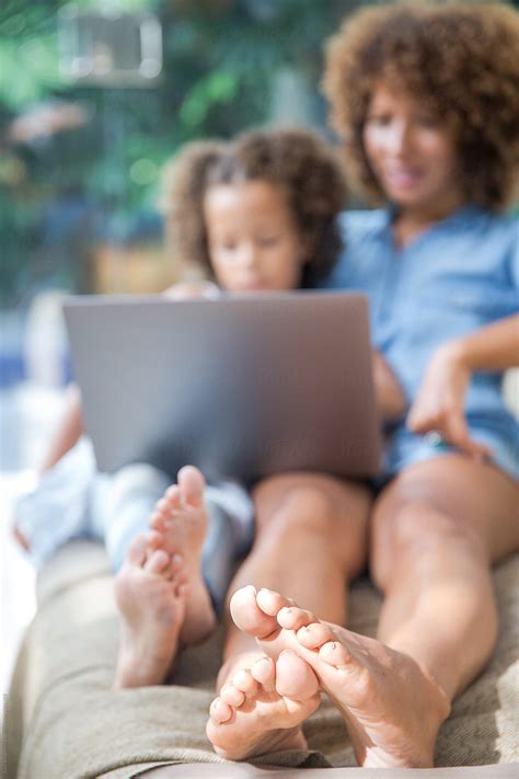 Mother And Daughters Feet Relaxing On Sofa Stock Image Everypixel