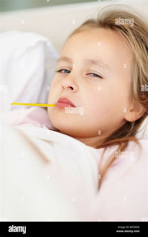 Girl Checking Temperature With Thermometer Stock Photo Alamy