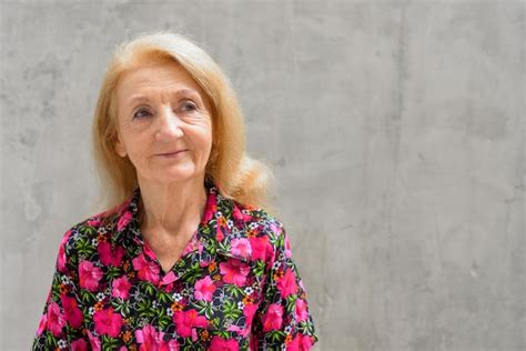 Premium Photo Portrait Of Woman Standing Against Wall