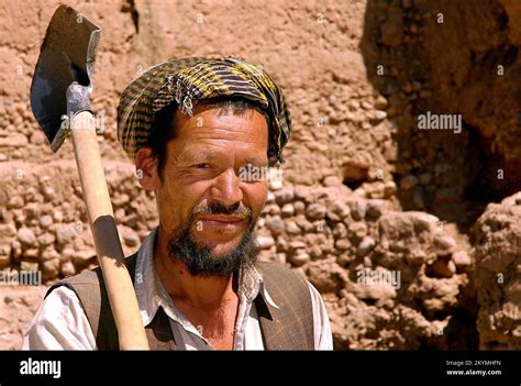 Bamyan Bamiyan Central Afghanistan A Man Carries A Shovel As He