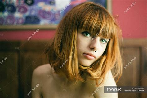 Portrait Of Redhead Girl With Nose Piercing Looking At Camera Stock Photo