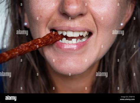 Woman Eats Food Woman Eats Kabanos Dry Sausage Close Shot Of Girl